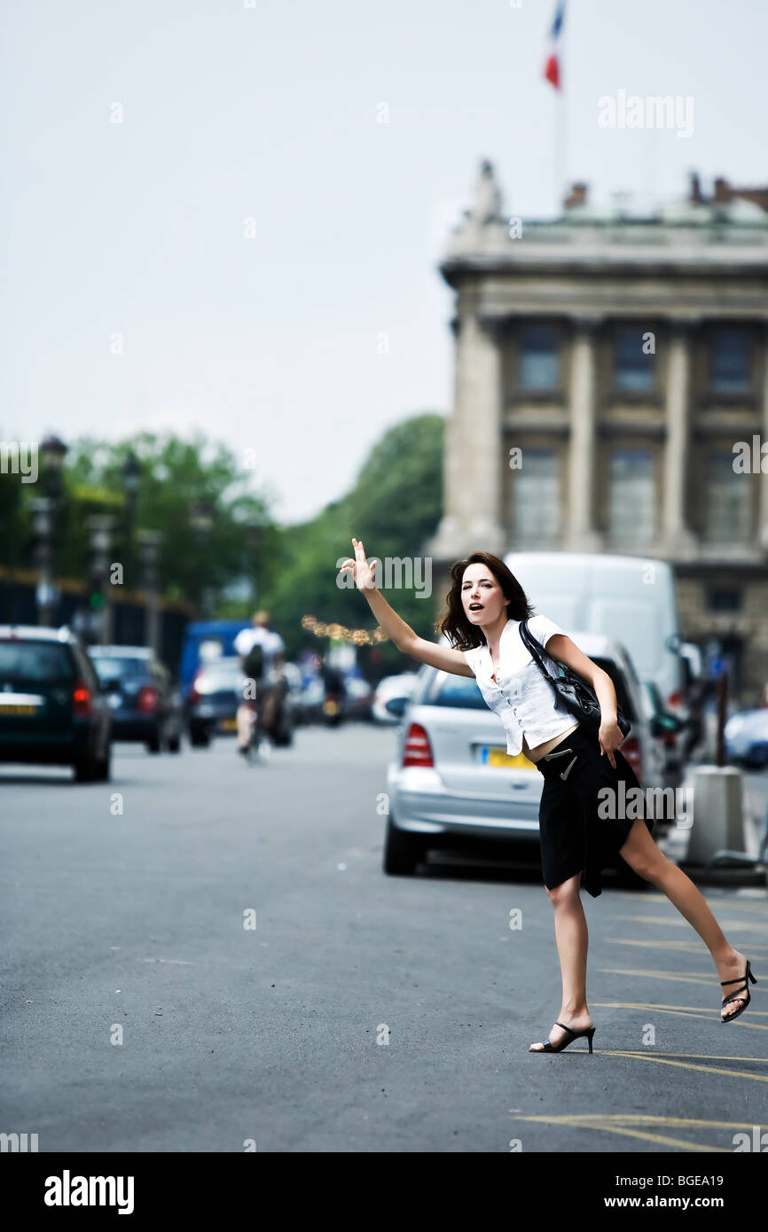 beautiful charming woman hailing a taxi cab in the street of paris ...