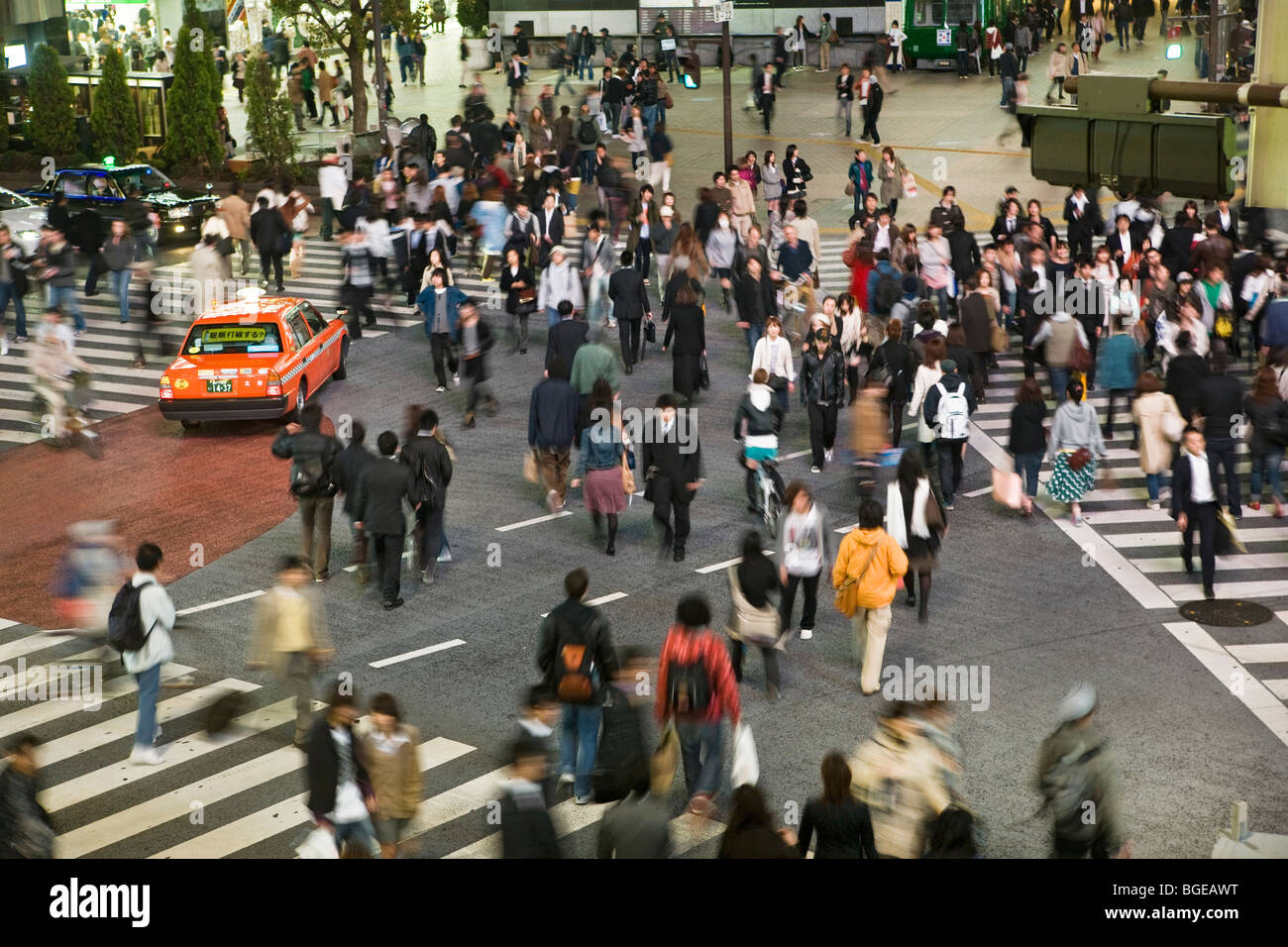 A crowd of people walking across a street in Shibuya Stock Photo - Alamy
