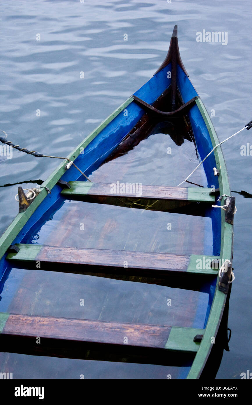 A boat filled to the brim with water Stock Photo - Alamy