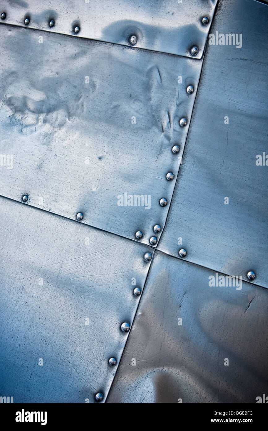 The battered hull of an airplane, reflecting incoming light Stock Photo ...