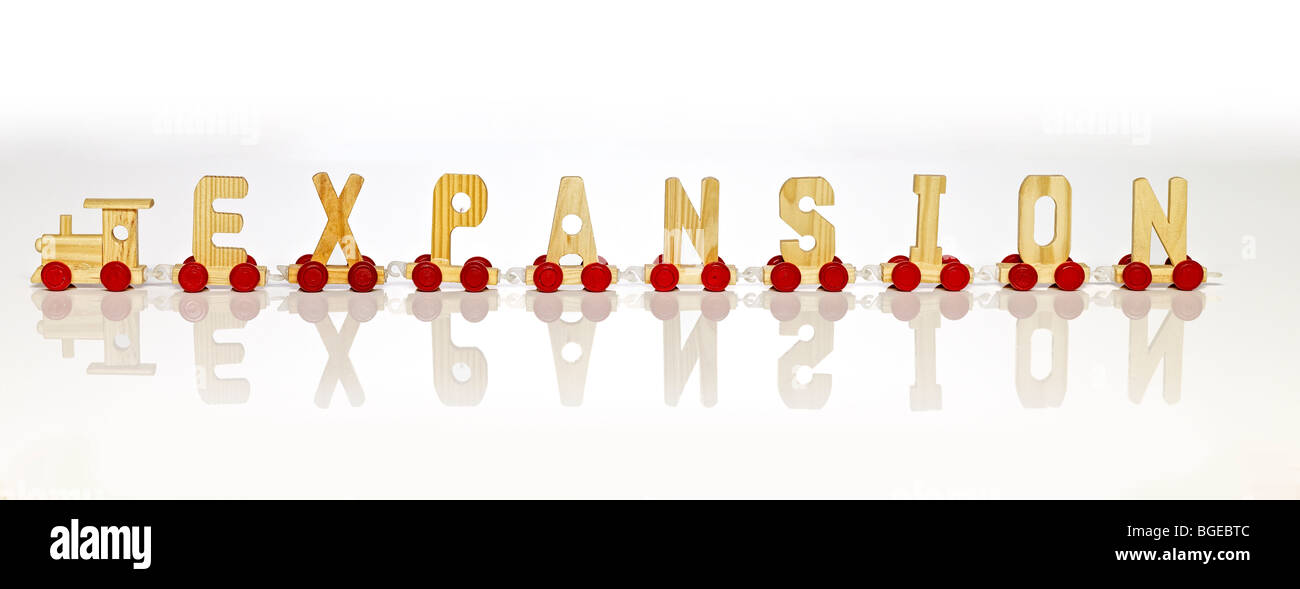 A toy letter carts train forming word expansion Stock Photo - Alamy