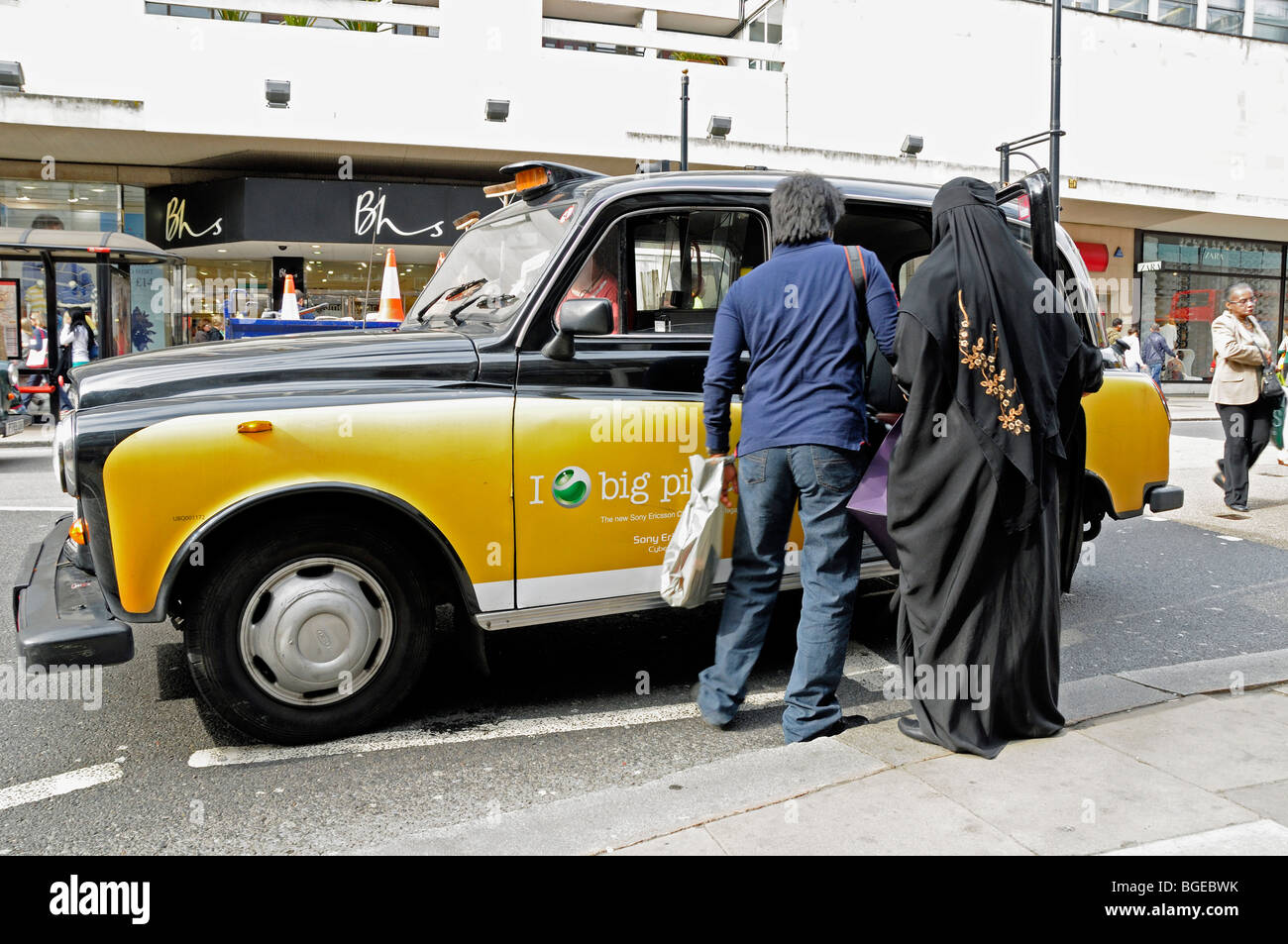 Couple entering taxi Oxford Street London England UK Stock Photo - Alamy