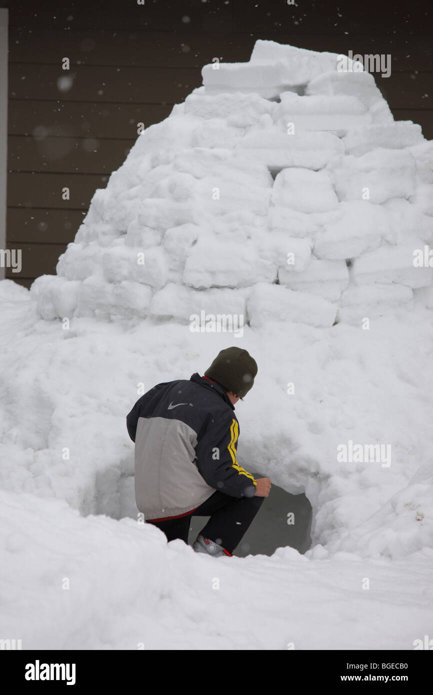 Boy enters igloo Stock Photo - Alamy