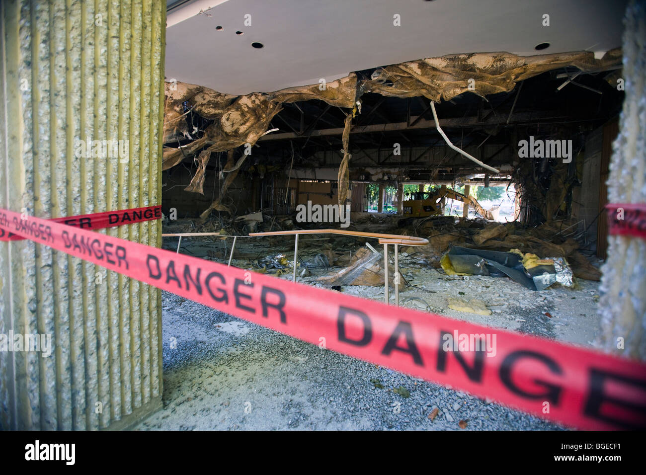 Danger tape around concrete column in a building that is being ...