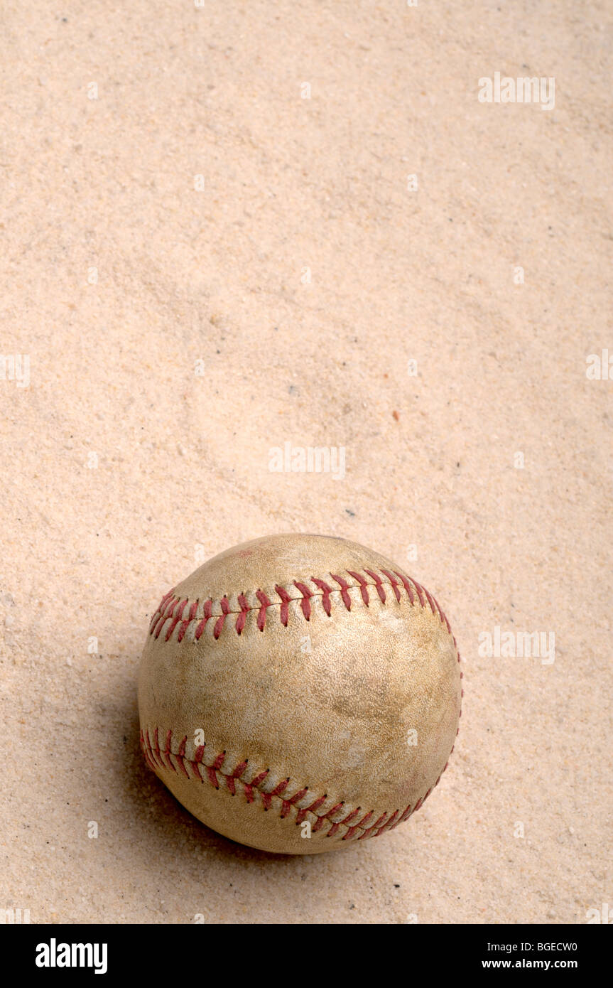 a vertical image of a baseball in the sand Stock Photo - Alamy