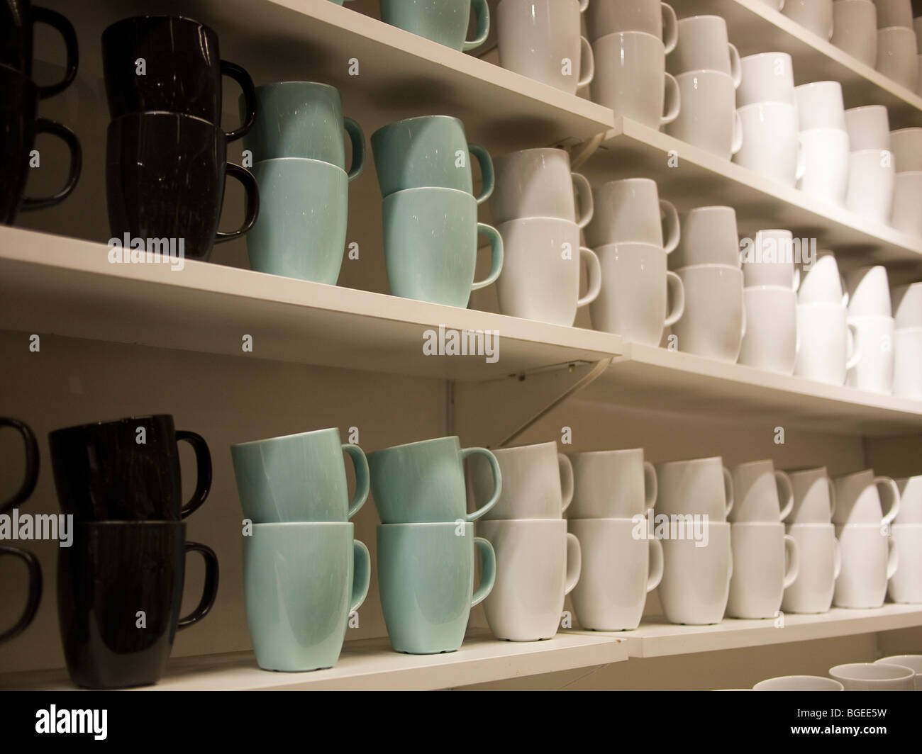 Rows of coloured cups on shelves Stock Photo - Alamy