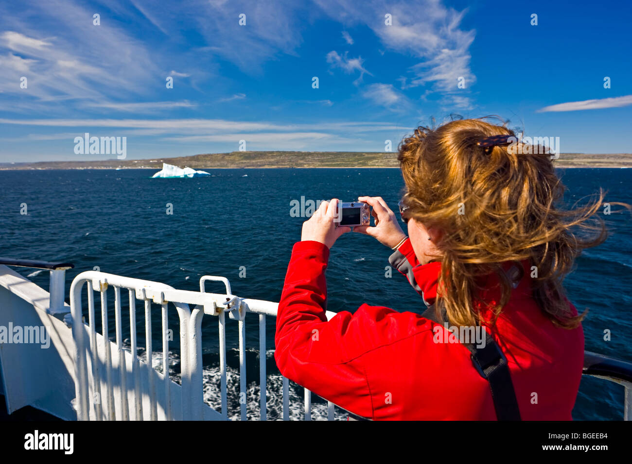 Tourist photographing an iceberg from onboard the Labrador Ferry ...