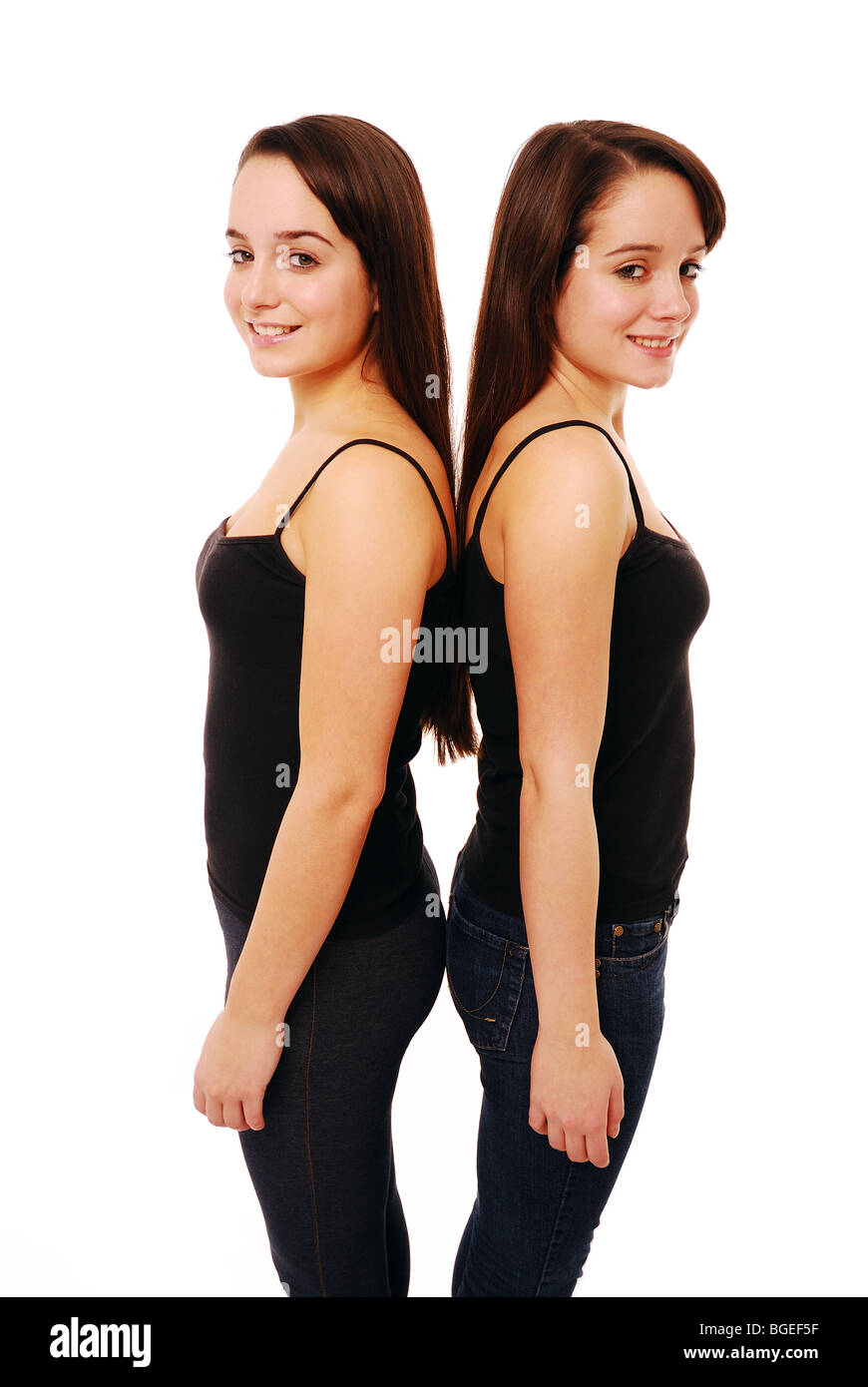 Twin girls holding hands back hi-res stock photography and images - Alamy