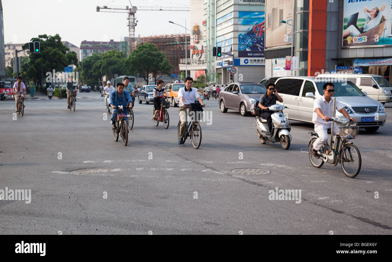 Moped riders and cyclists in Shanghai Stock Photo - Alamy