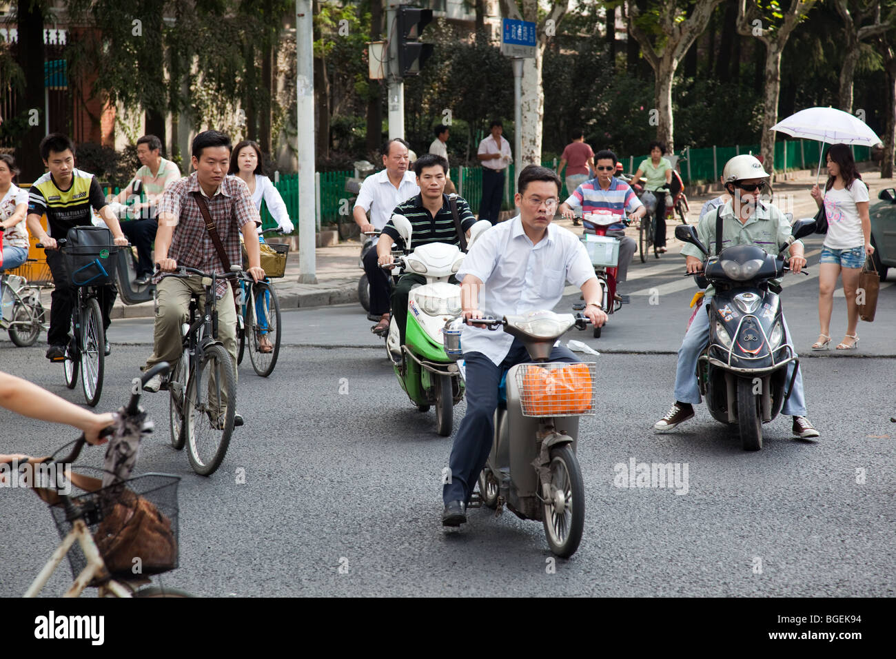 Moped riders and cyclists in Shanghai Stock Photo - Alamy