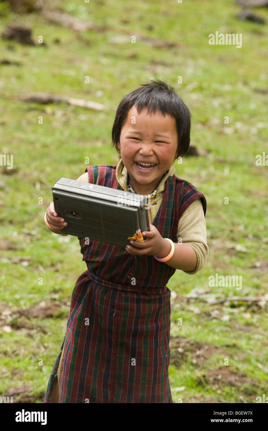 Young girl, Yak herding family, enjoys radio, Pele La Pass, ca 11,000 ...