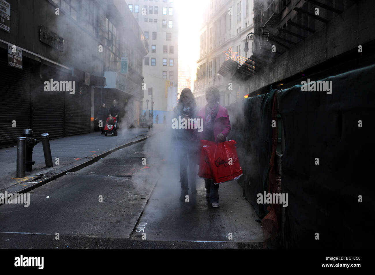 Steam rises from the street to engulf shoppers in Manhattan New York ...