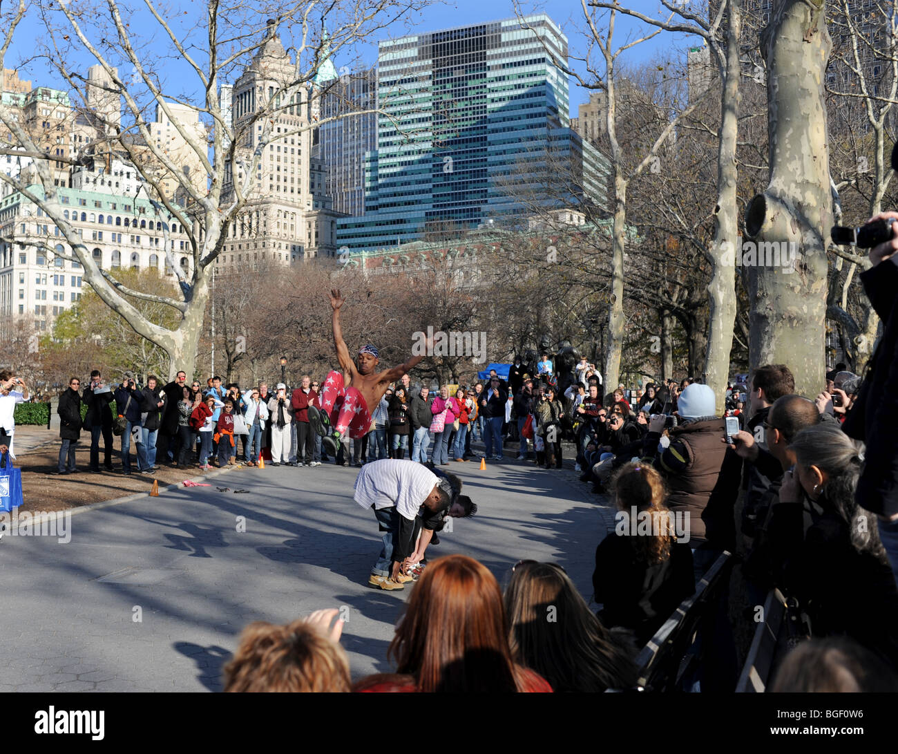 Buskers entertain a crowd at battery Park in Manhattan New York USA ...