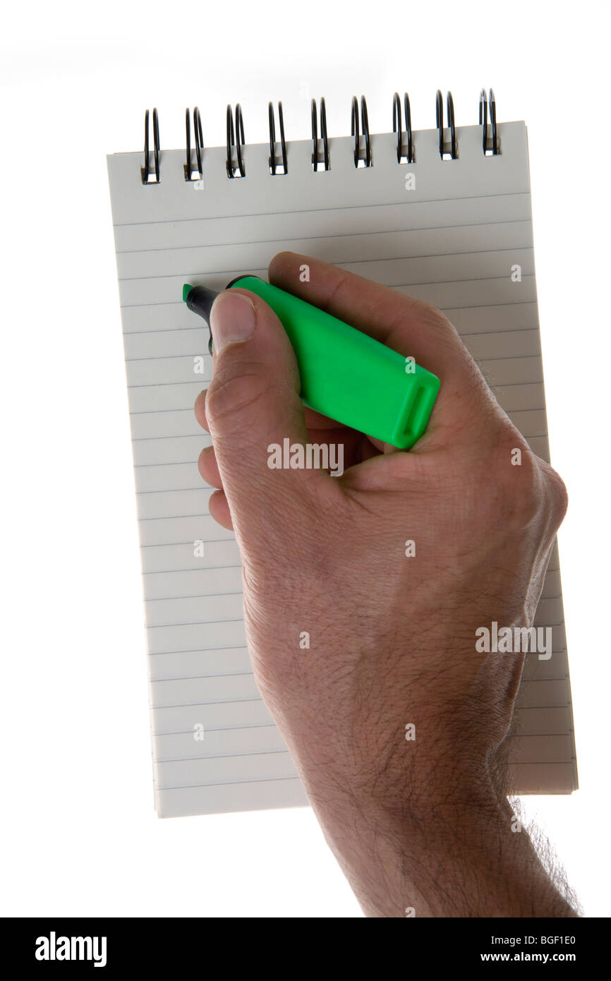 mans hand hold pen on note book Stock Photo - Alamy