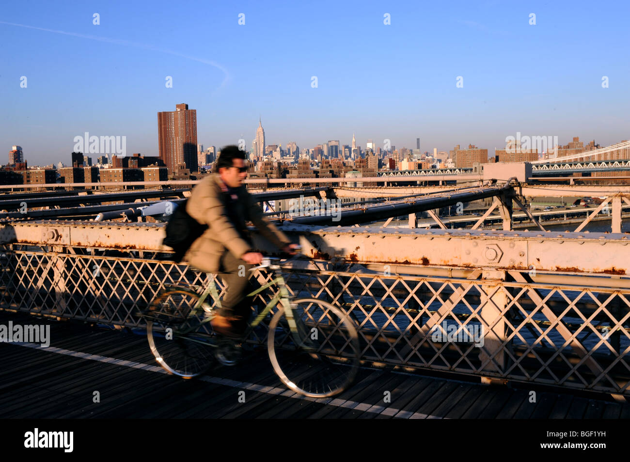 Cyclists cross Brooklyn Bridge in Manhattan New York USA Stock Photo ...