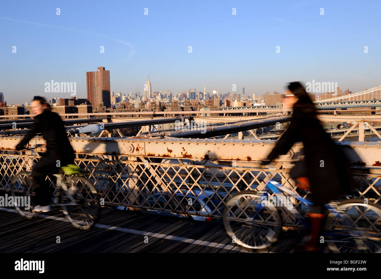 Cyclists cross Brooklyn Bridge in Manhattan New York USA Stock Photo ...