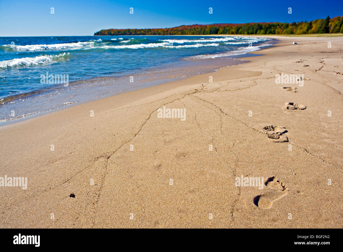 Footprints in the sand along the beach of Pancake Bay in Pancake Bay ...