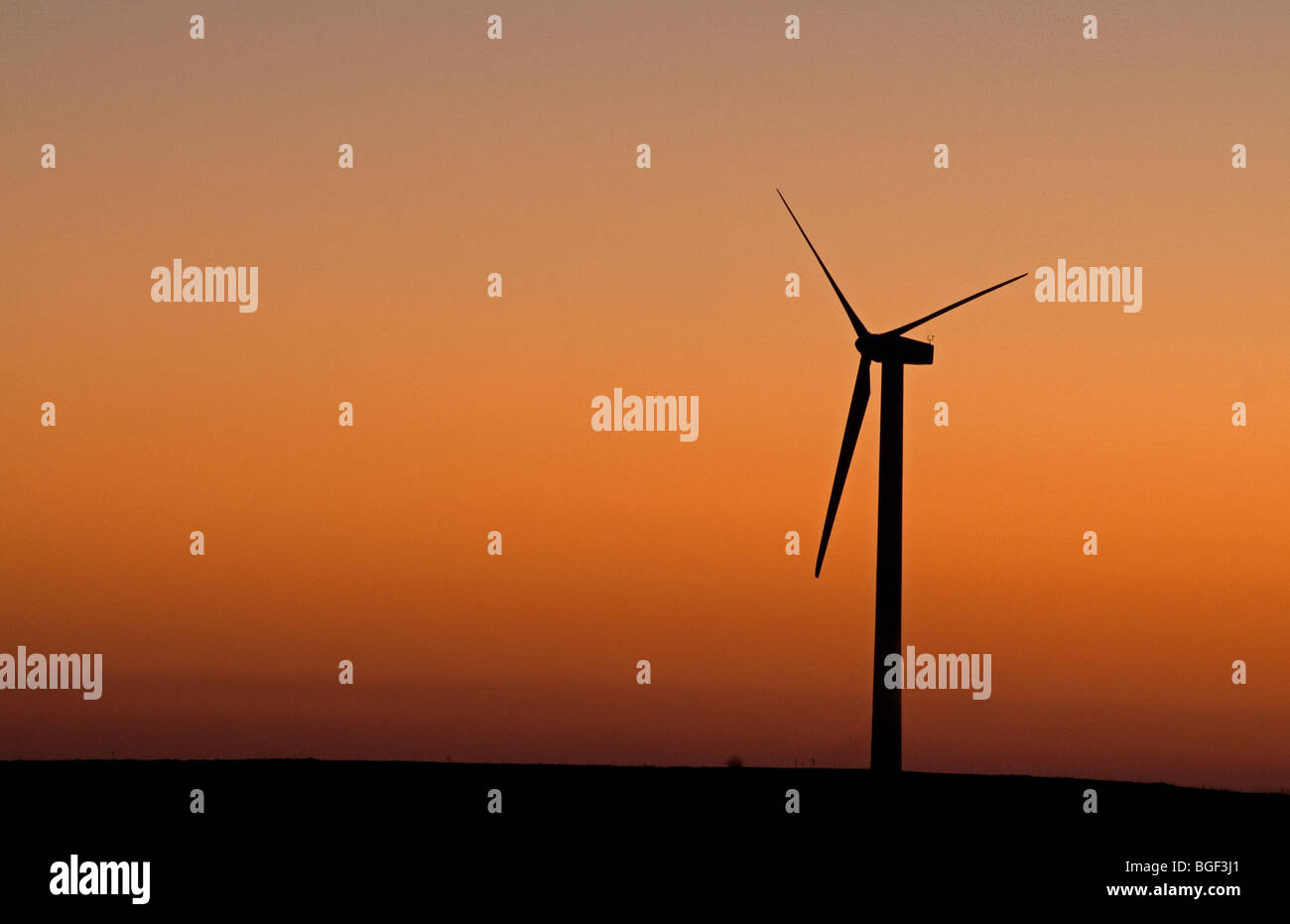 Windfarm windmill at sunset Stock Photo - Alamy