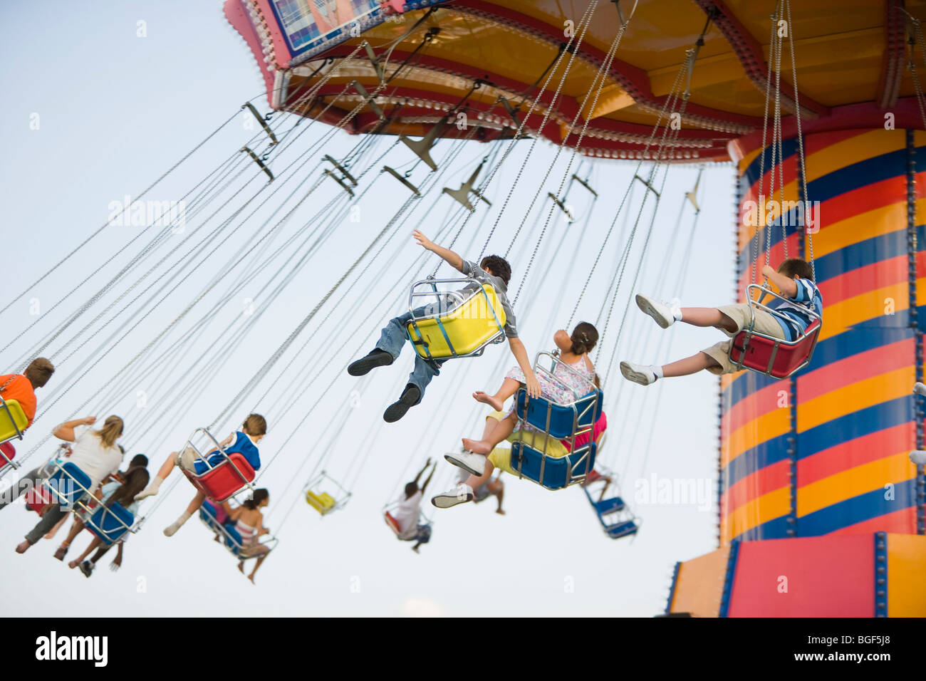 Group of kids riding the spinning swing at an amusement park, Navy Pier ...