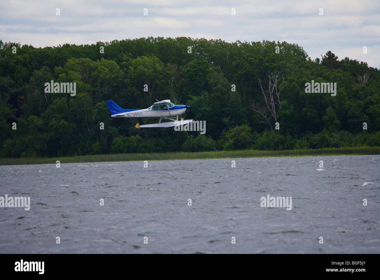 Float plane taking off from fishing lake plane in sky Stock Photo - Alamy