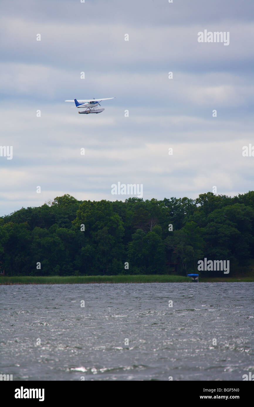 Float plane taking off from fishing lake plane in sky Stock Photo - Alamy