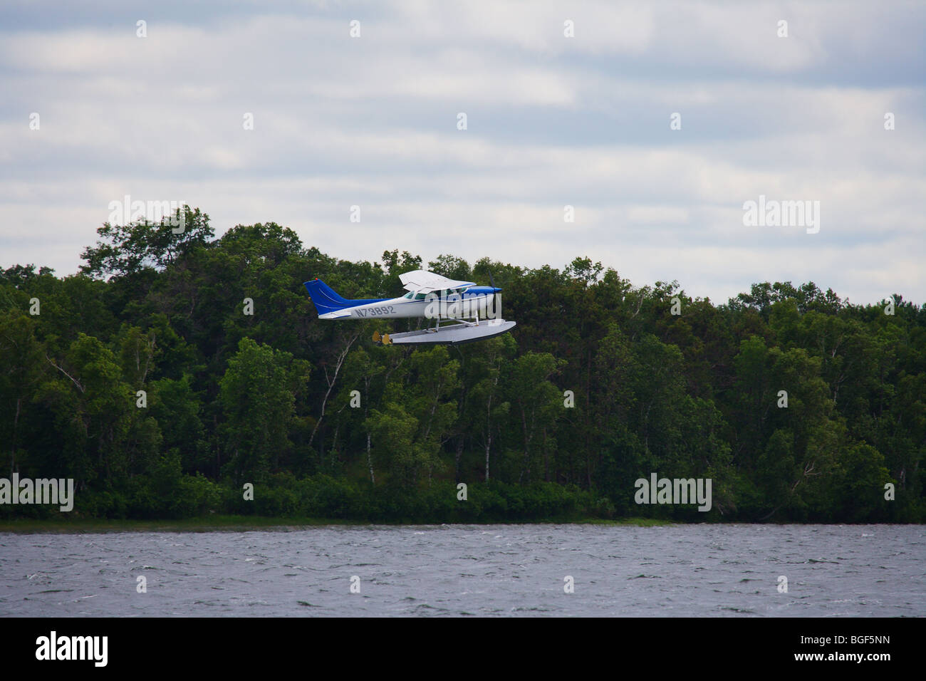 Float plane taking off from fishing lake plane in sky Stock Photo - Alamy