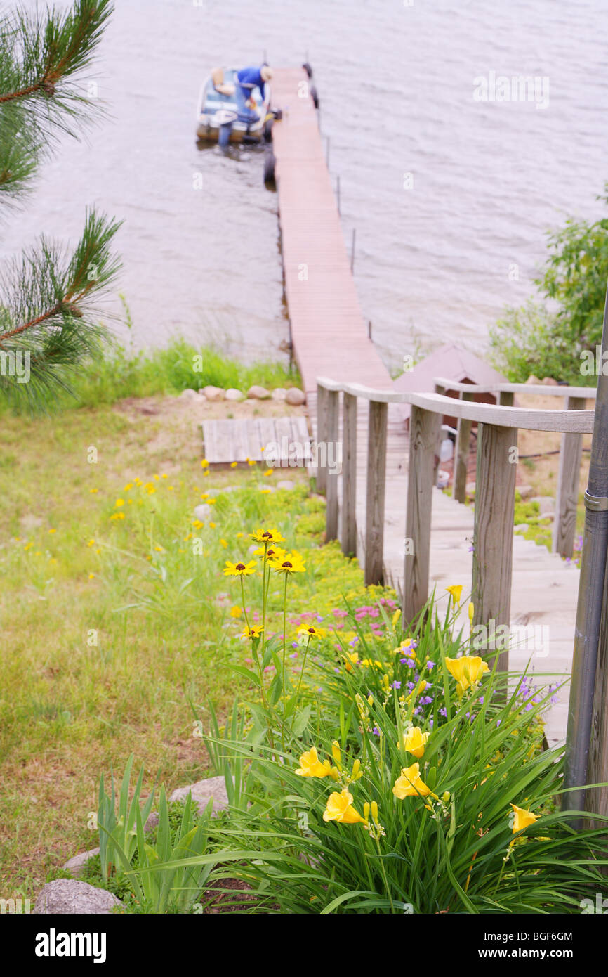 Wooden ramp leading to fishing boat and boat dock on fishing lake ...