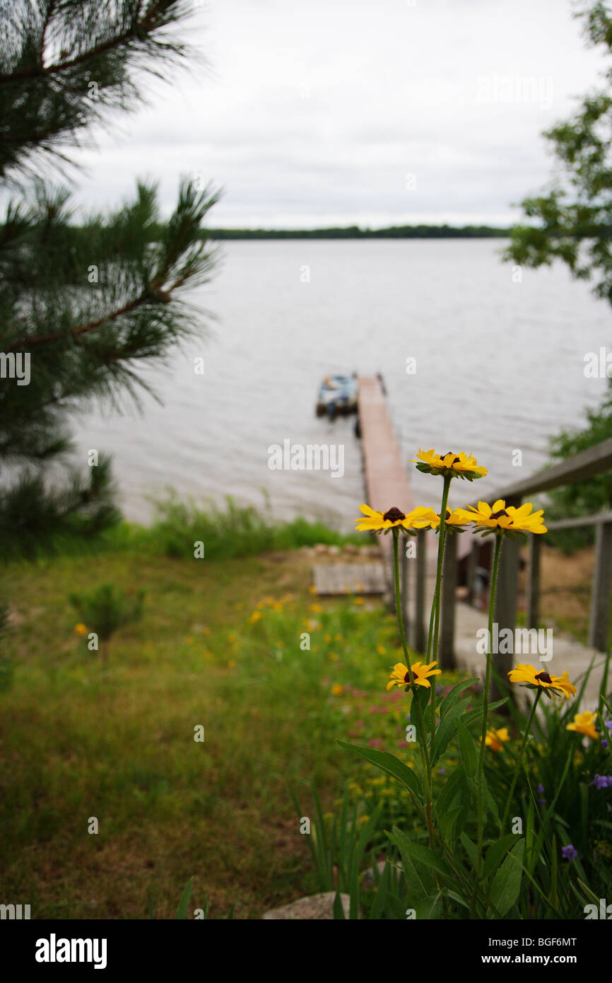 Wooden ramp leading to fishing boat and boat dock on fishing lake ...