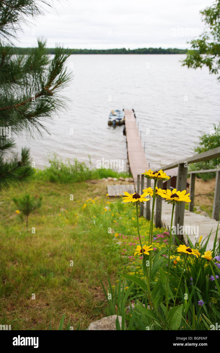 Wooden ramp leading to fishing boat and boat dock on fishing lake ...