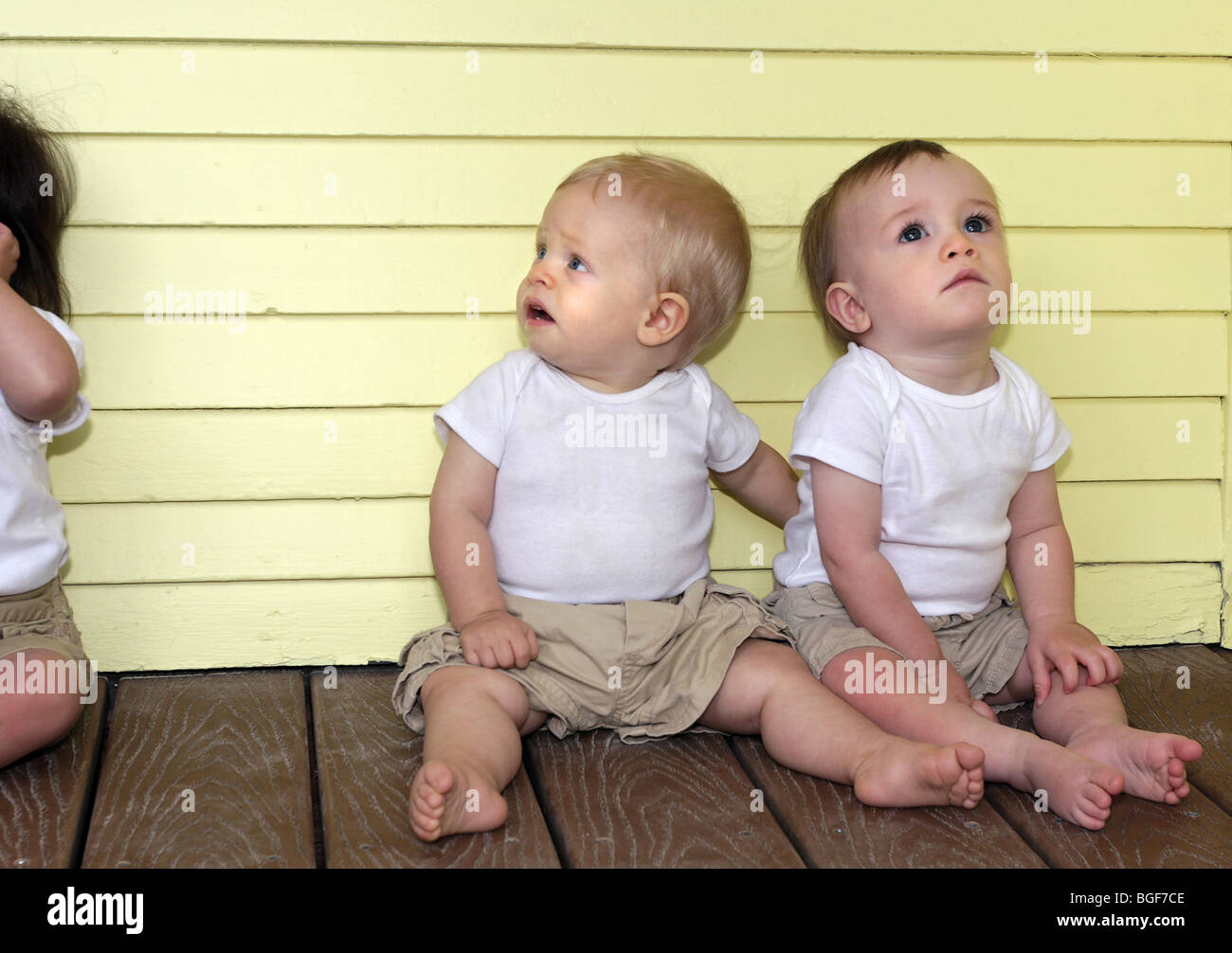 Two babies sitting together Stock Photo - Alamy
