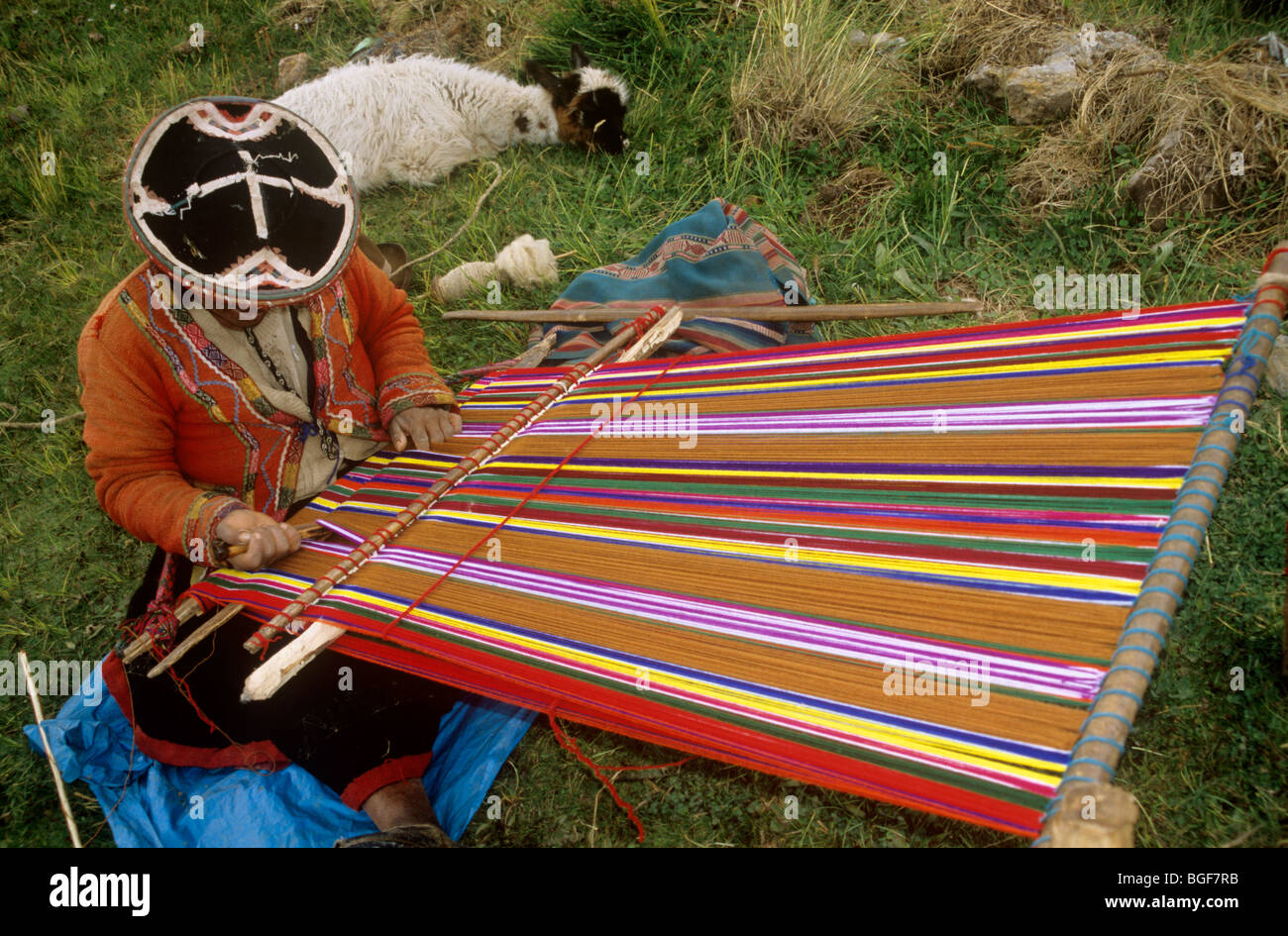 Peruvian woman on loom weaving a wool scarf or shawl, for future sale ...
