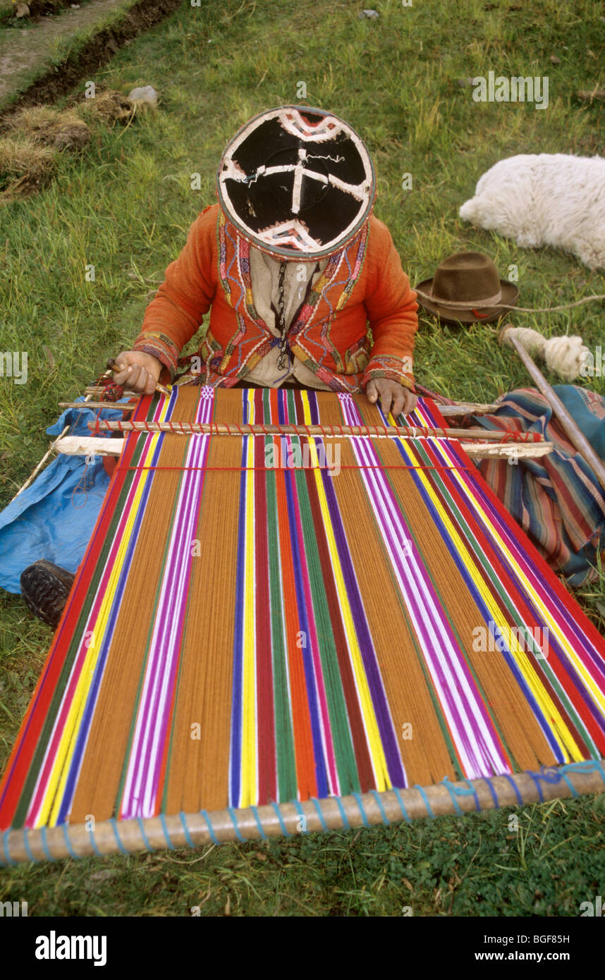 Peruvian woman on loom weaving a wool scarf or shawl, for future sale ...