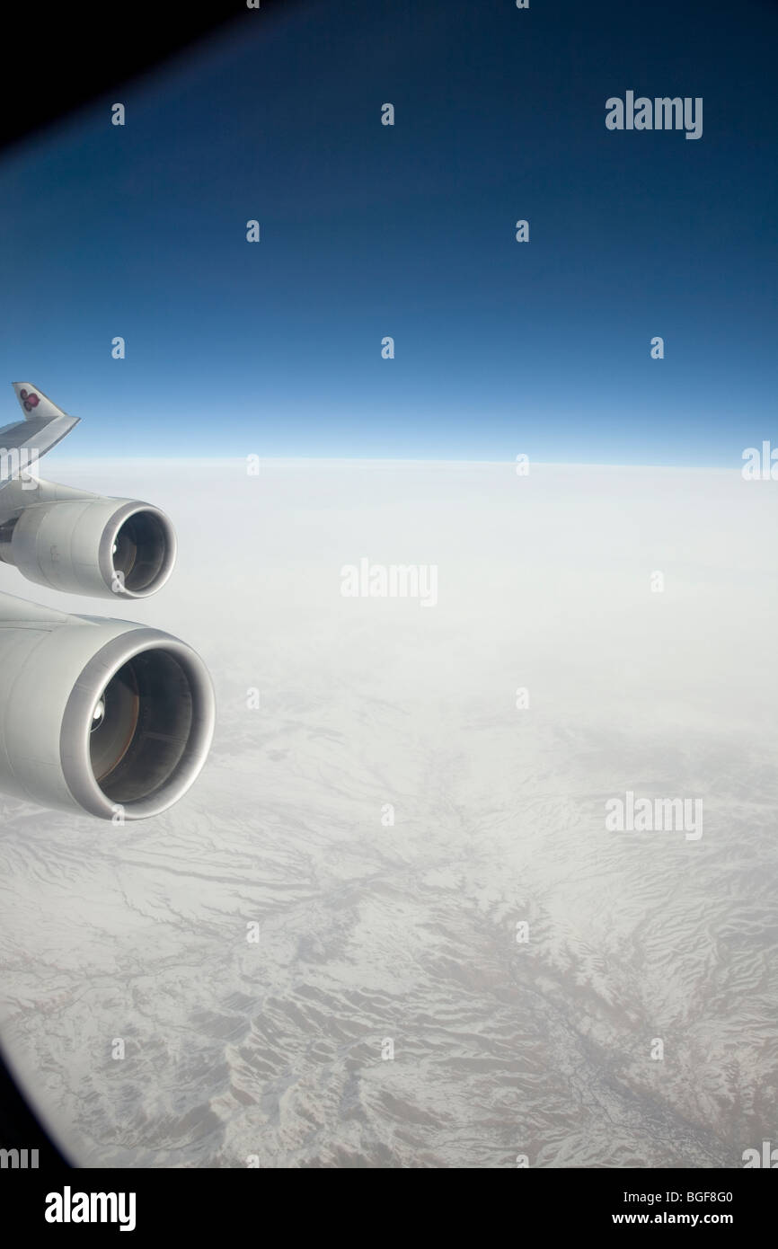 Thai Airplane flying over snowy terrain (Afghanistan Stock Photo - Alamy