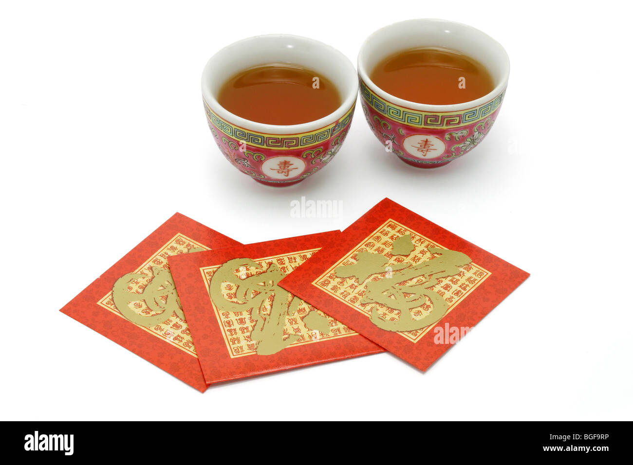 Chinese longevity tea cups and red packets for tea ceremony on white ...