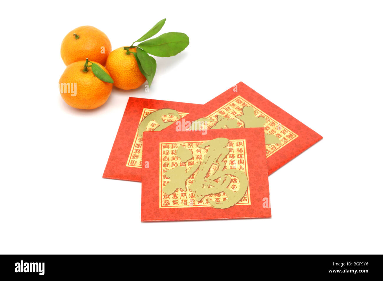 Chinese New Year mandarin oranges and red packets on white background ...