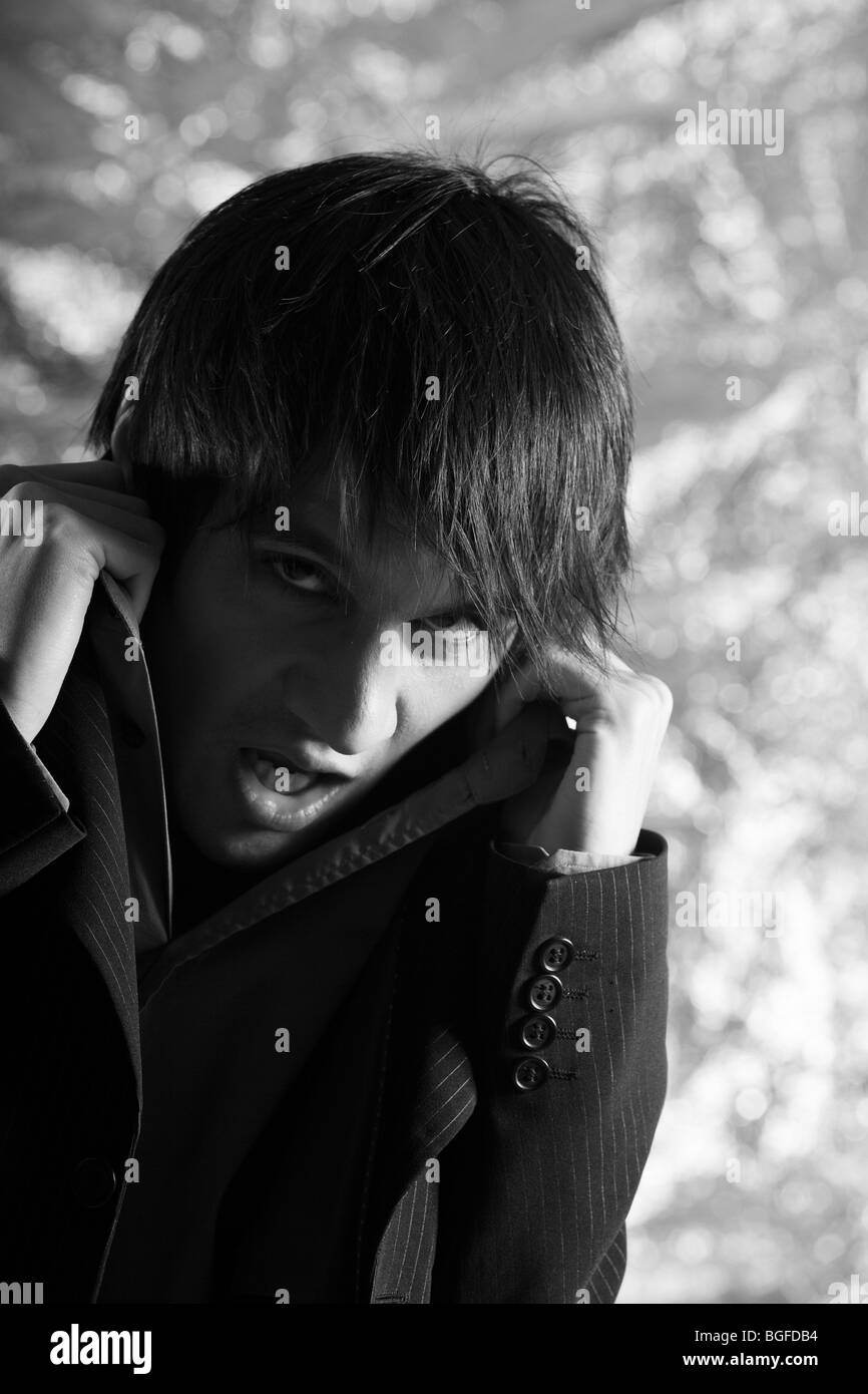 Studio shot of an handsome and expressive man on isolated silver ...