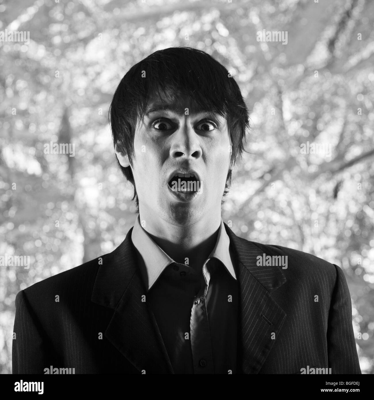 Studio shot of an handsome and expressive man on isolated silver ...