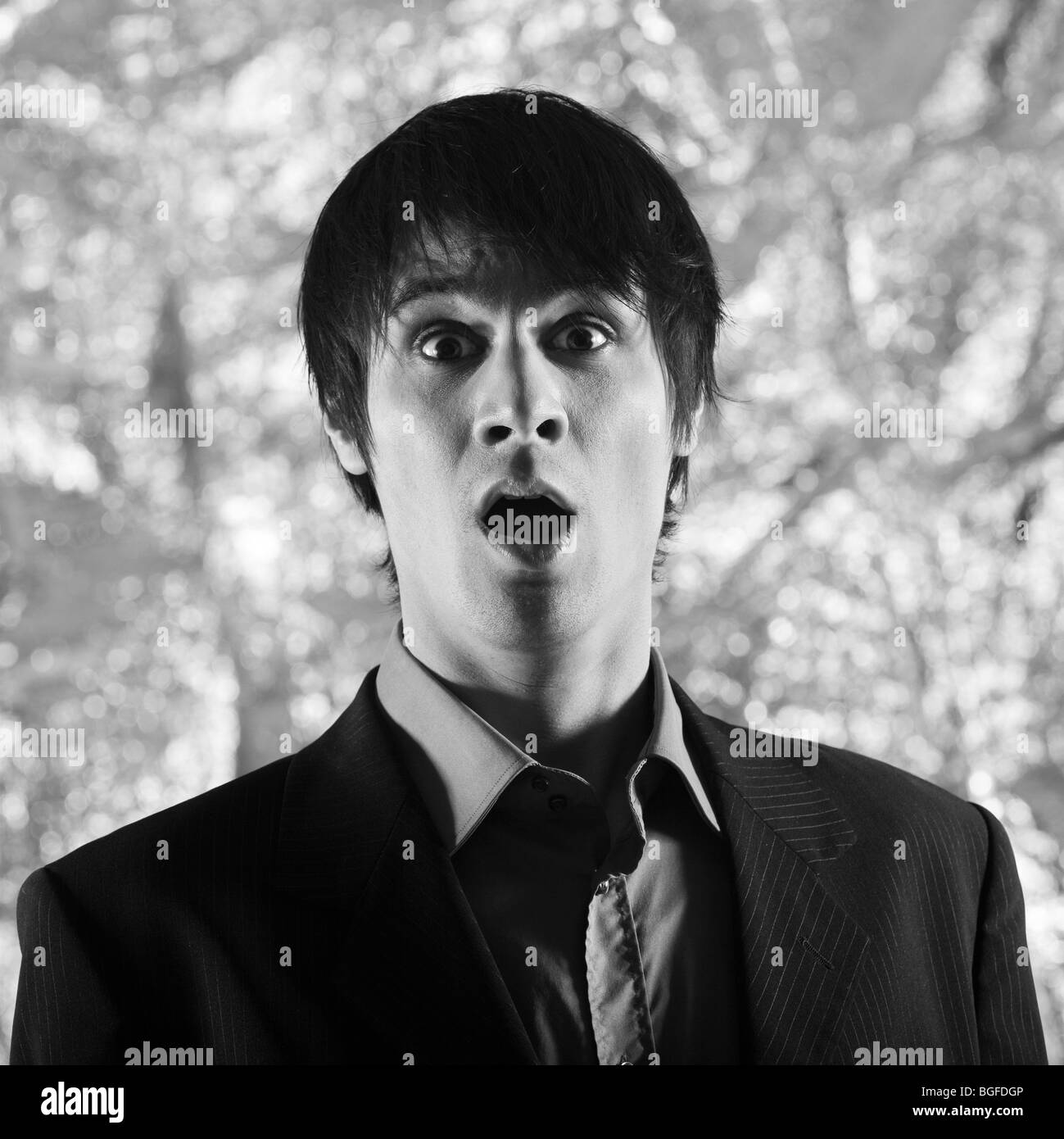 Studio shot of an handsome and expressive man on isolated silver ...