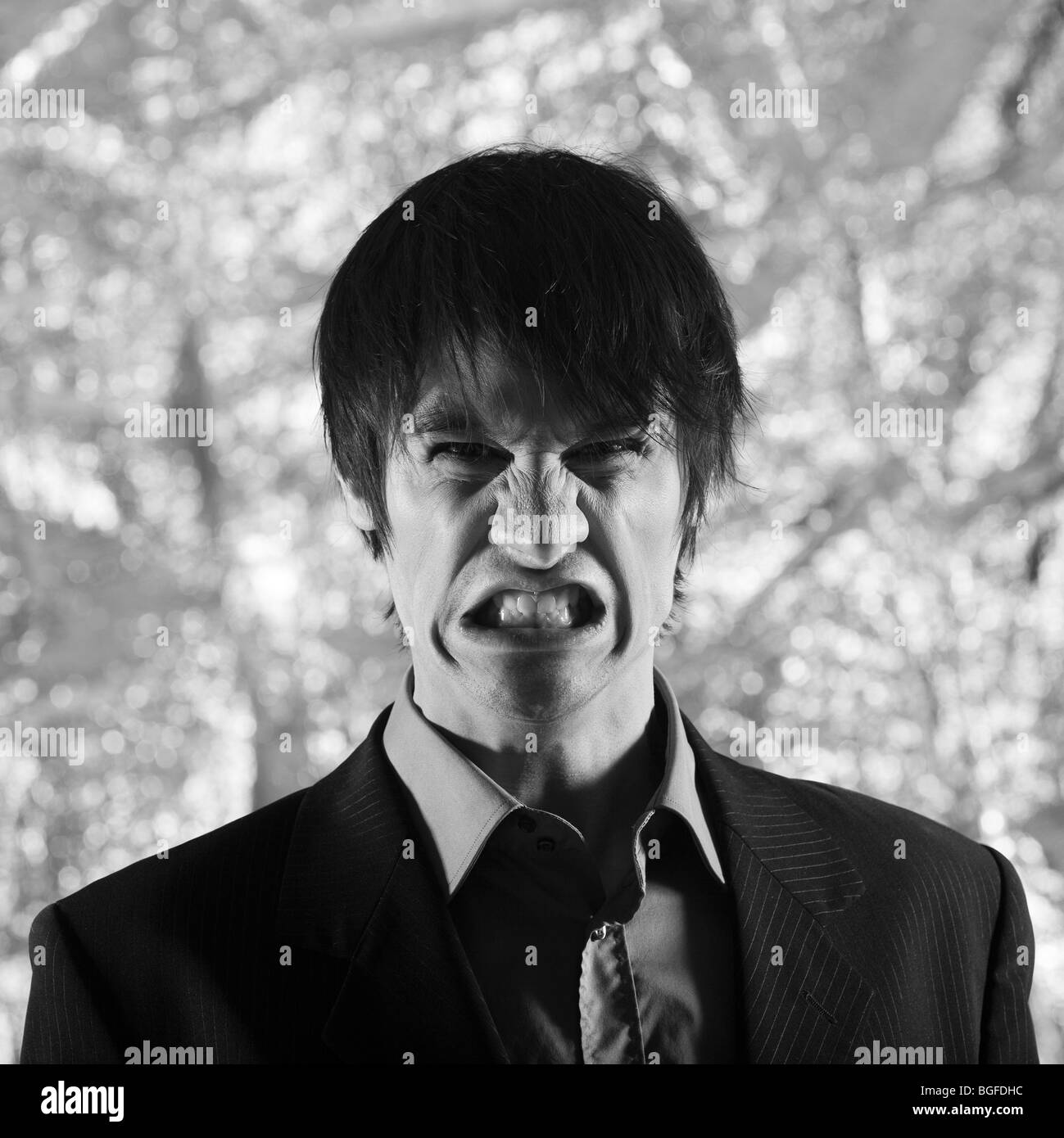 Studio shot of an handsome and expressive man on isolated silver ...