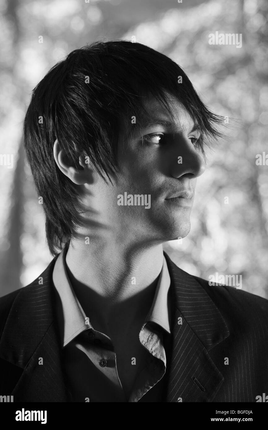 Studio shot of an handsome and expressive man on isolated silver ...