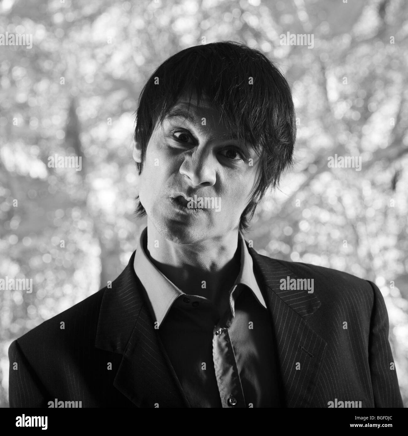 Studio shot of an handsome and expressive man on isolated silver ...