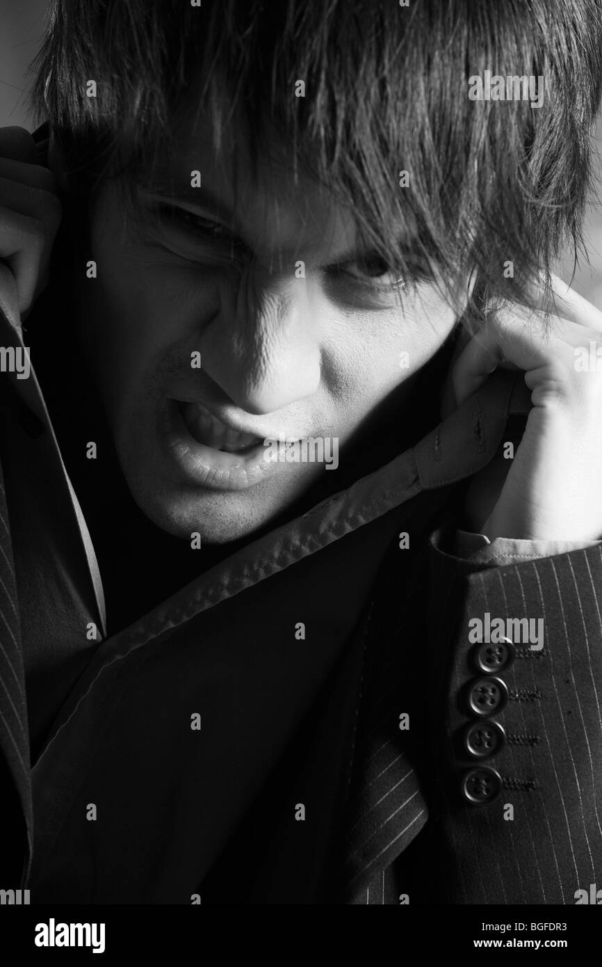 Studio shot of an handsome and expressive man on isolated silver ...