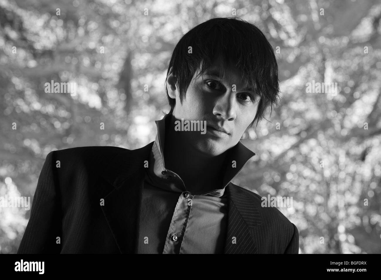 Studio shot of an handsome and expressive man on isolated silver ...