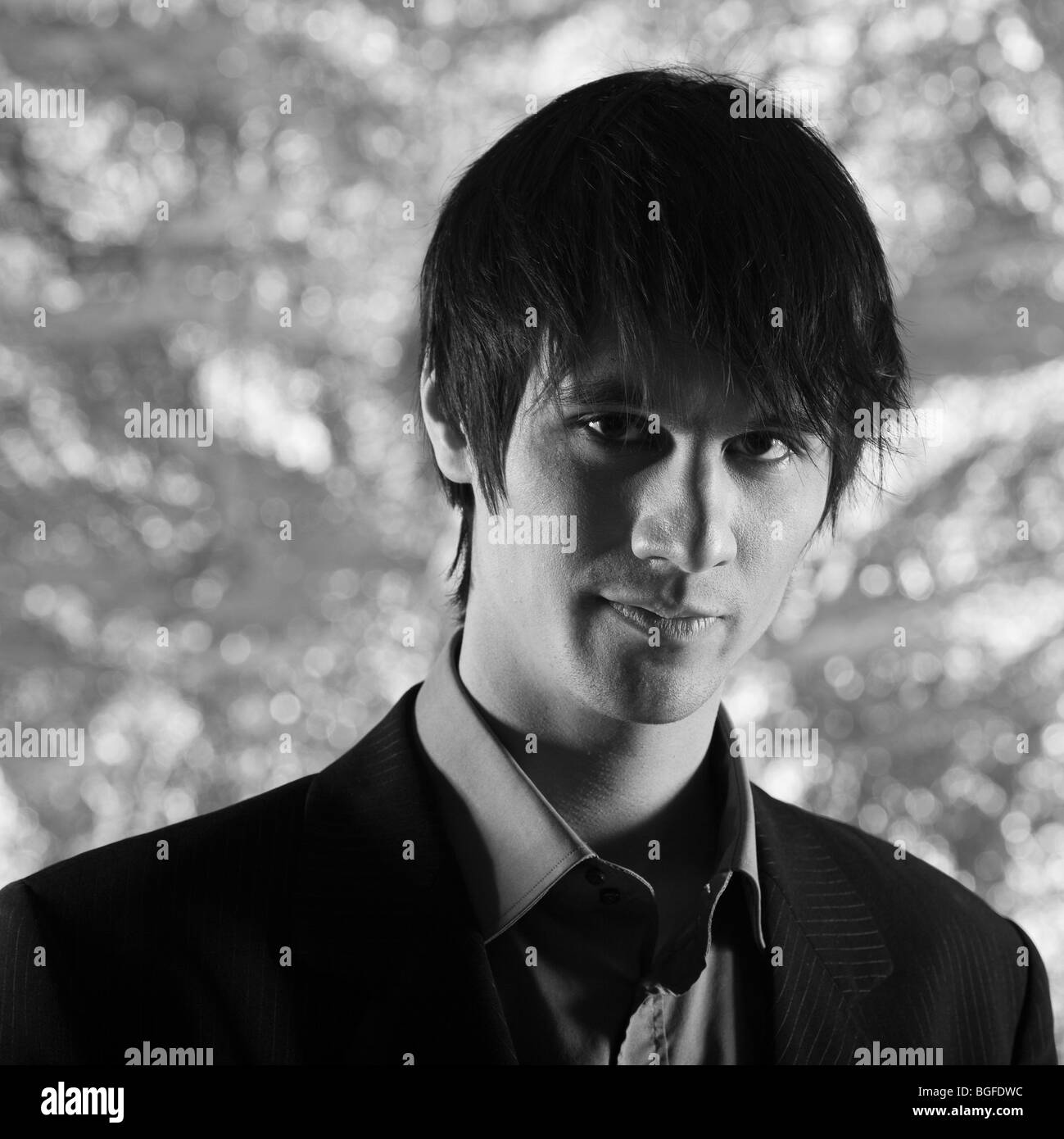 Studio shot of an handsome and expressive man on isolated silver ...