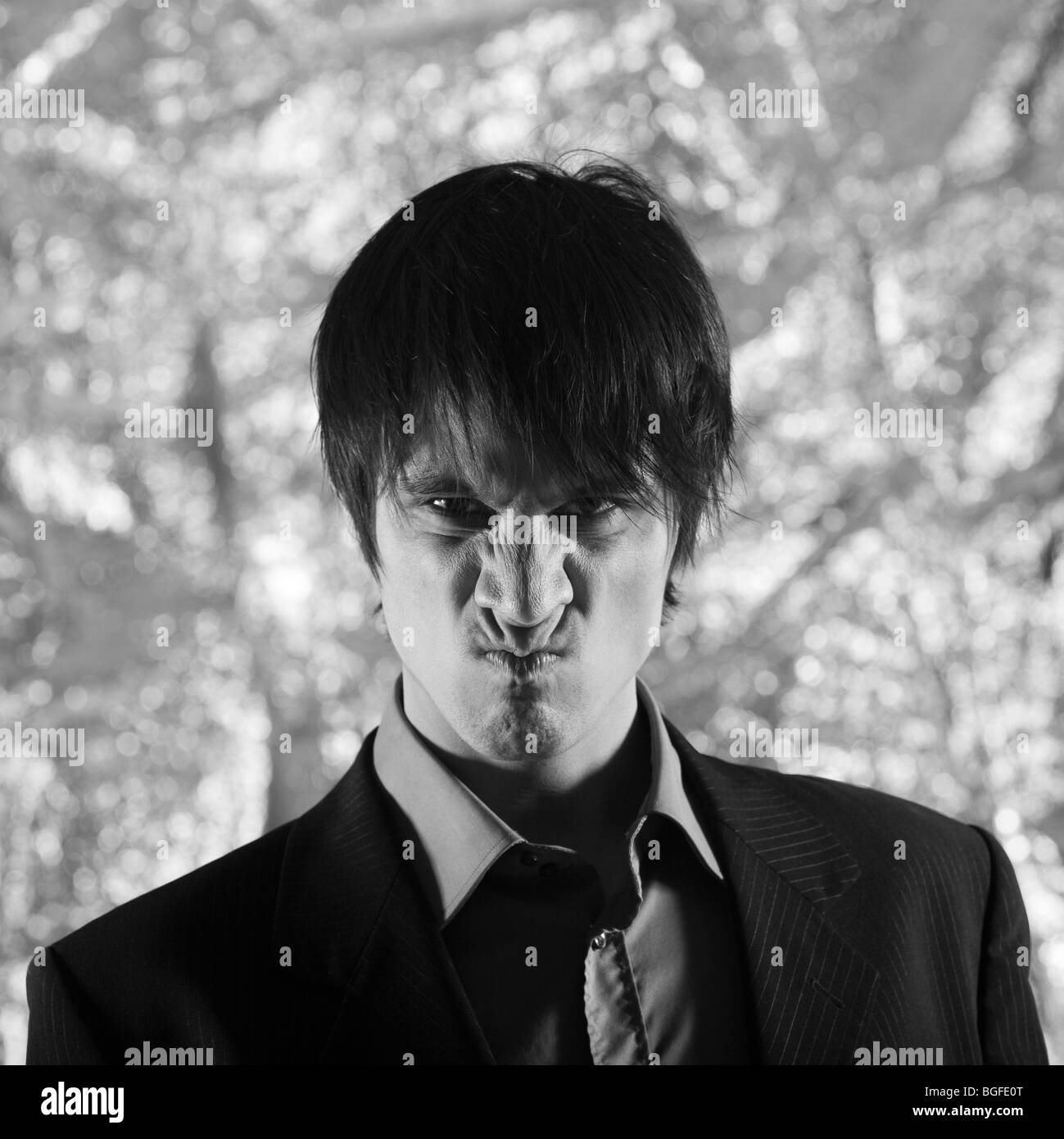 Studio shot of an handsome and expressive man on isolated silver ...