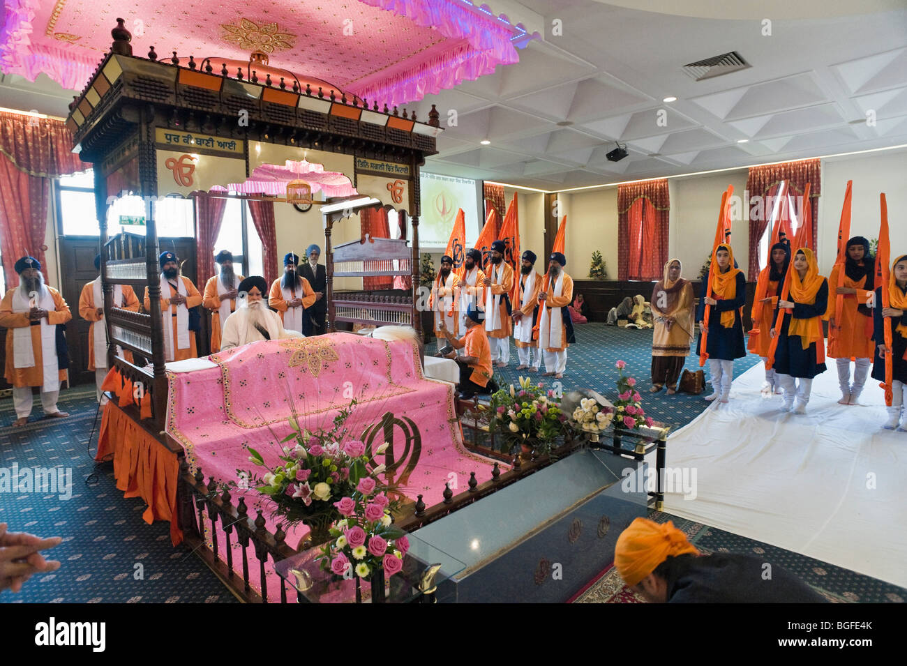 Panj Piyare & men and young women with Nisan Sahibs stand round the ...