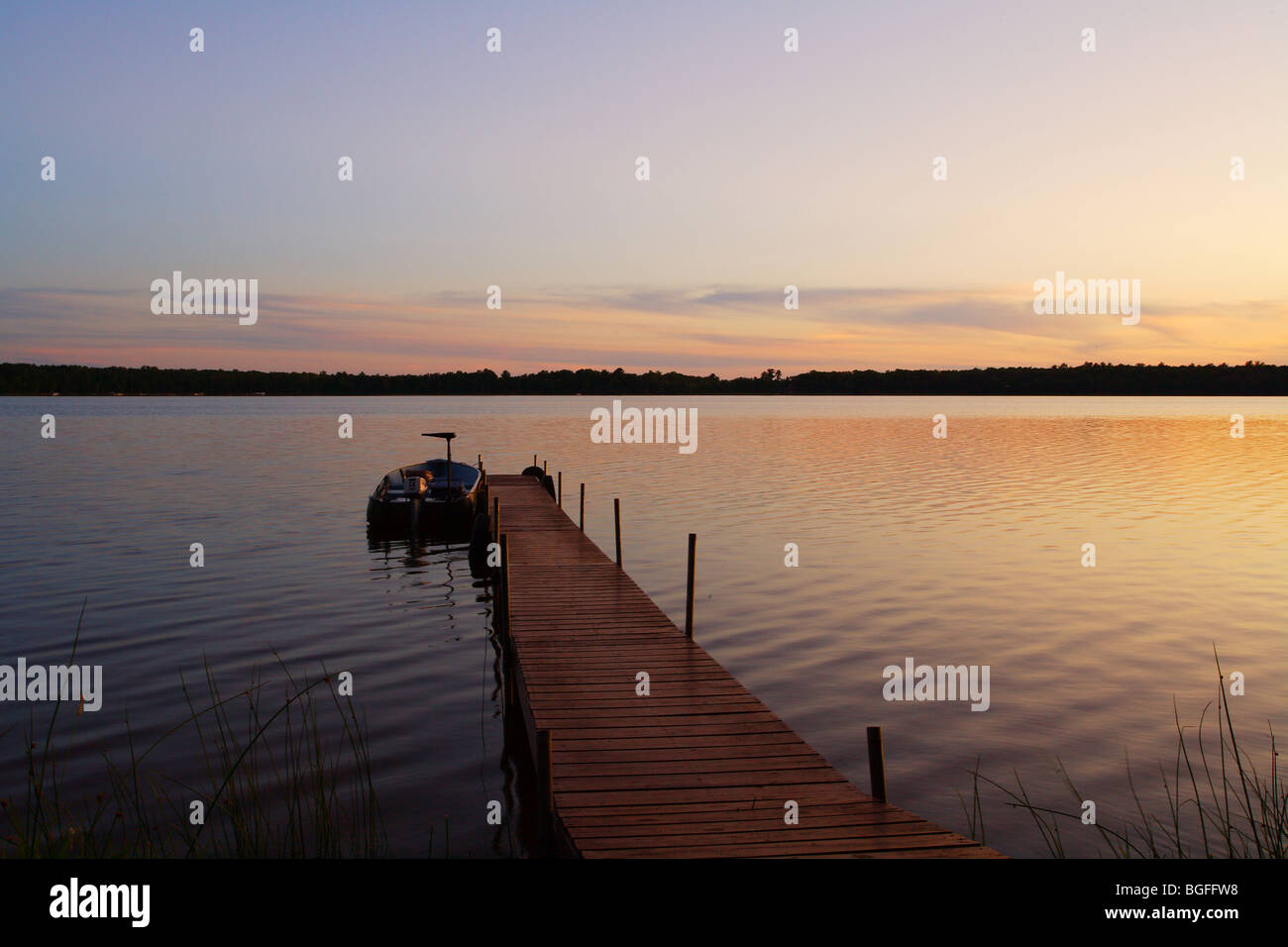 wooden boat ramp leading to boat and boat dock sitting on large fishing ...