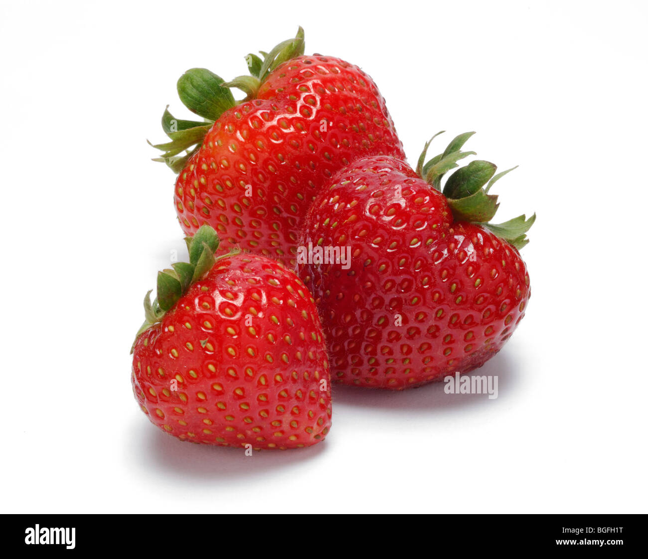 Three beautiful whole red strawberries together Stock Photo - Alamy