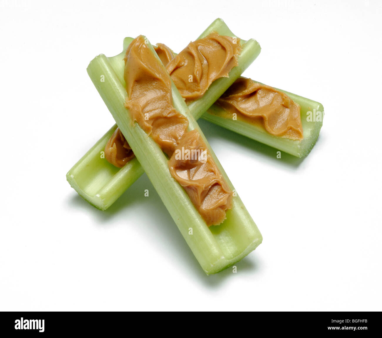 Three short pieces of celery the peanut butter applied Stock Photo - Alamy