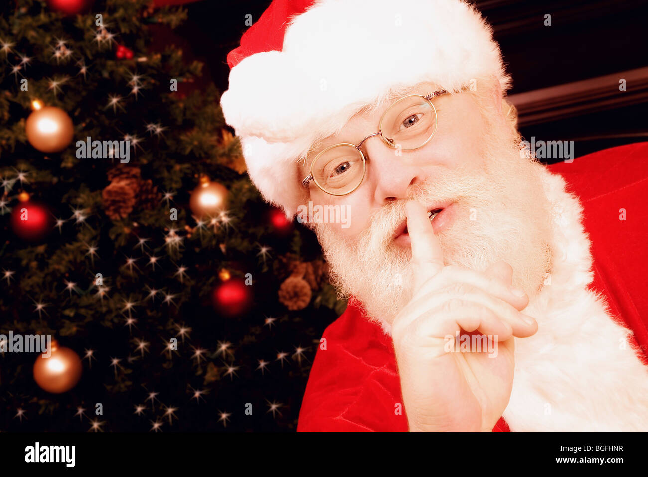 Santa Claus with finger to lips Stock Photo - Alamy